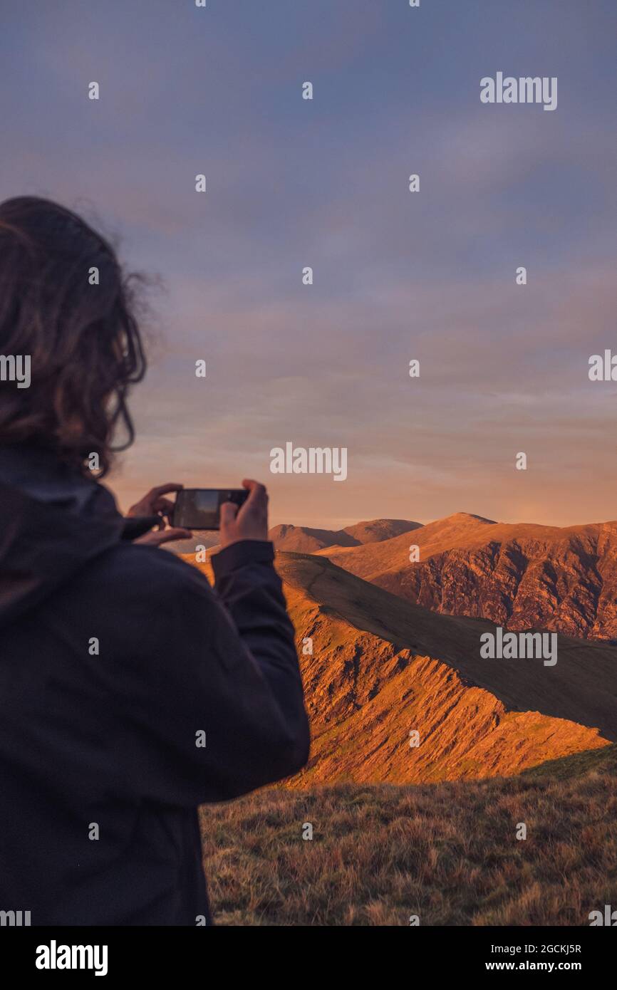 Back view of man taking picture with smartphone hi-res stock ...