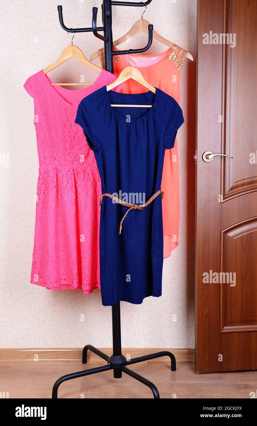 Dresses hanging on hanger near door Stock Photo - Alamy
