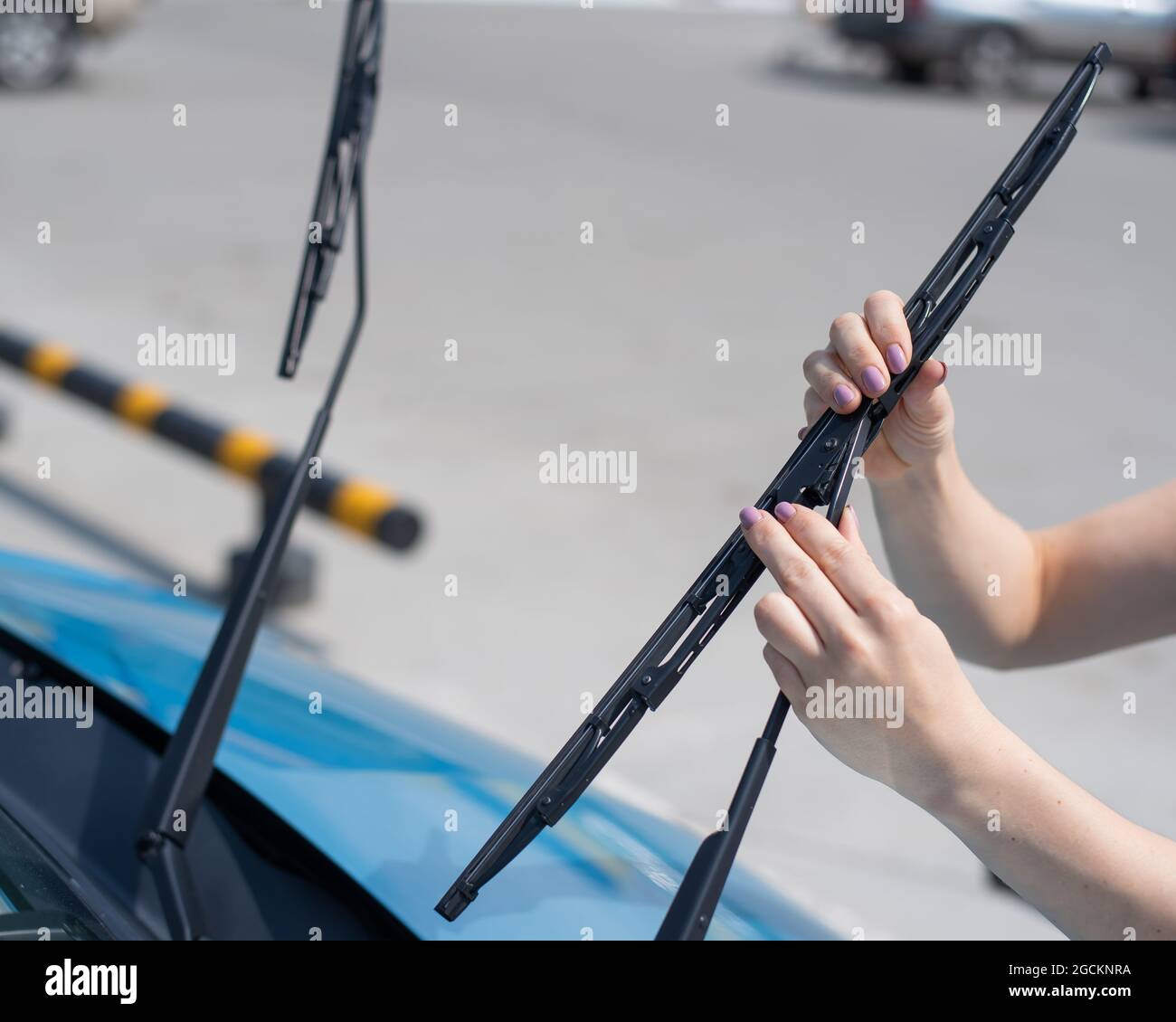 Faceless woman changing car windshield wipers Stock Photo - Alamy