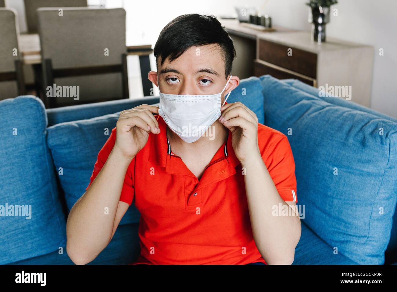 High angle of ethnic teenage boy with Down syndrome wearing protective ...