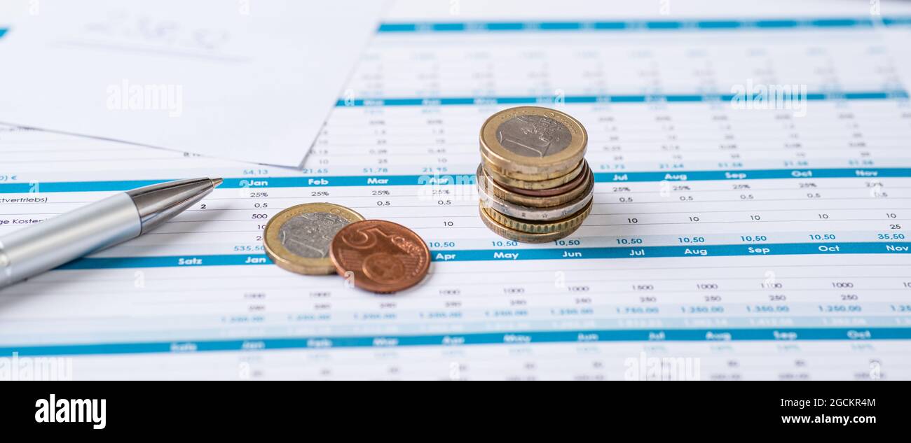Financial documents with coins Stock Photo - Alamy
