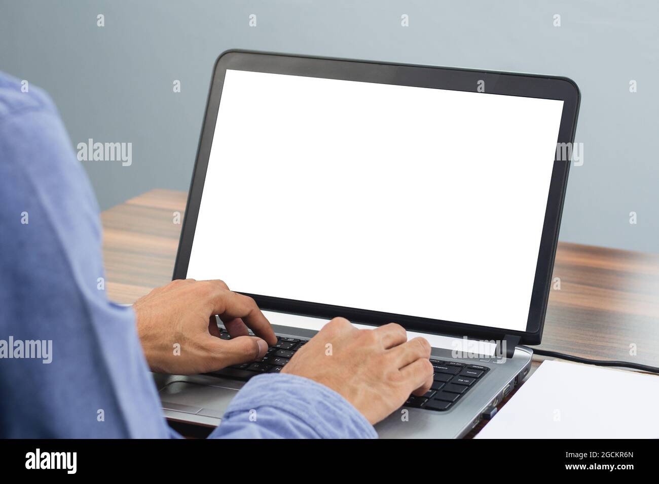 Man suing computer screen mockup in office Stock Photo - Alamy