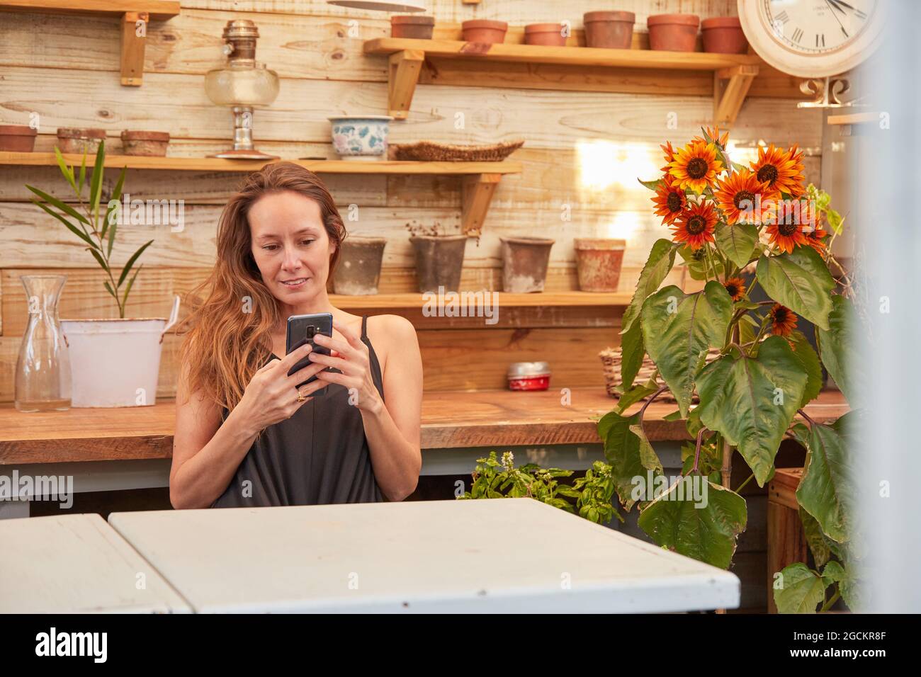 Side view of young content Arab female wearing red hijab standing on ...