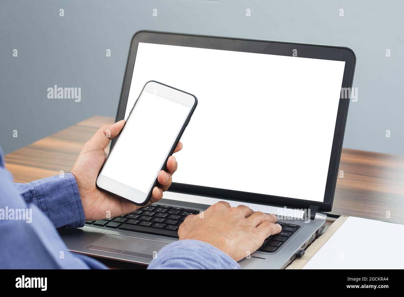 Closeup hand suing mobile smartphone in office work ,phone screen mock ...
