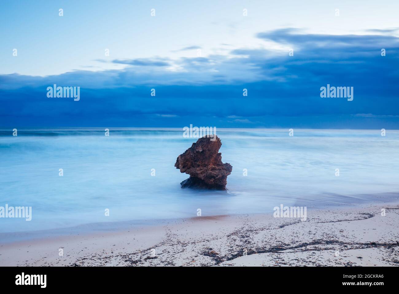The idyllic Number Sixteen Beach with an incoming storm at dusk in Rye ...