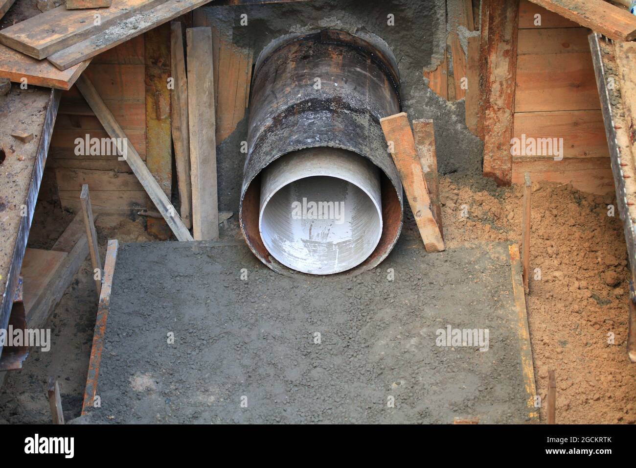 City communications. Laying a sewer pipe in a pit. Fragment of ...