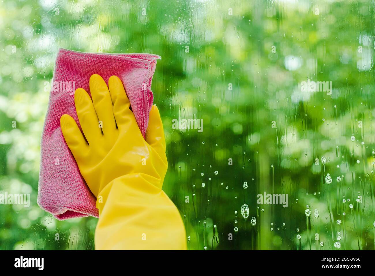 woman spraying and wiping glass Stock Photo - Alamy