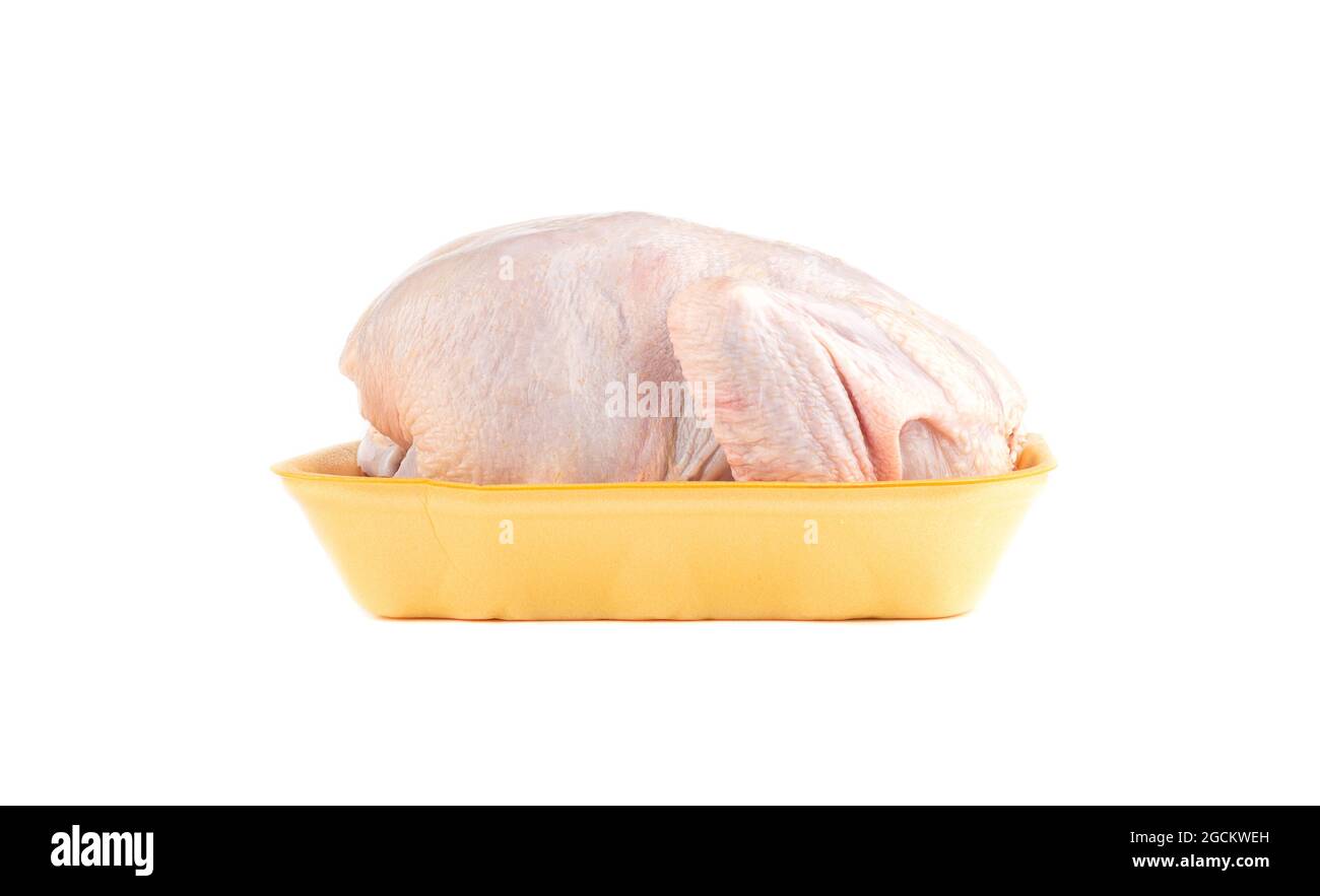 Whole fresh chicken in a plastic tray isolated on a white background ...