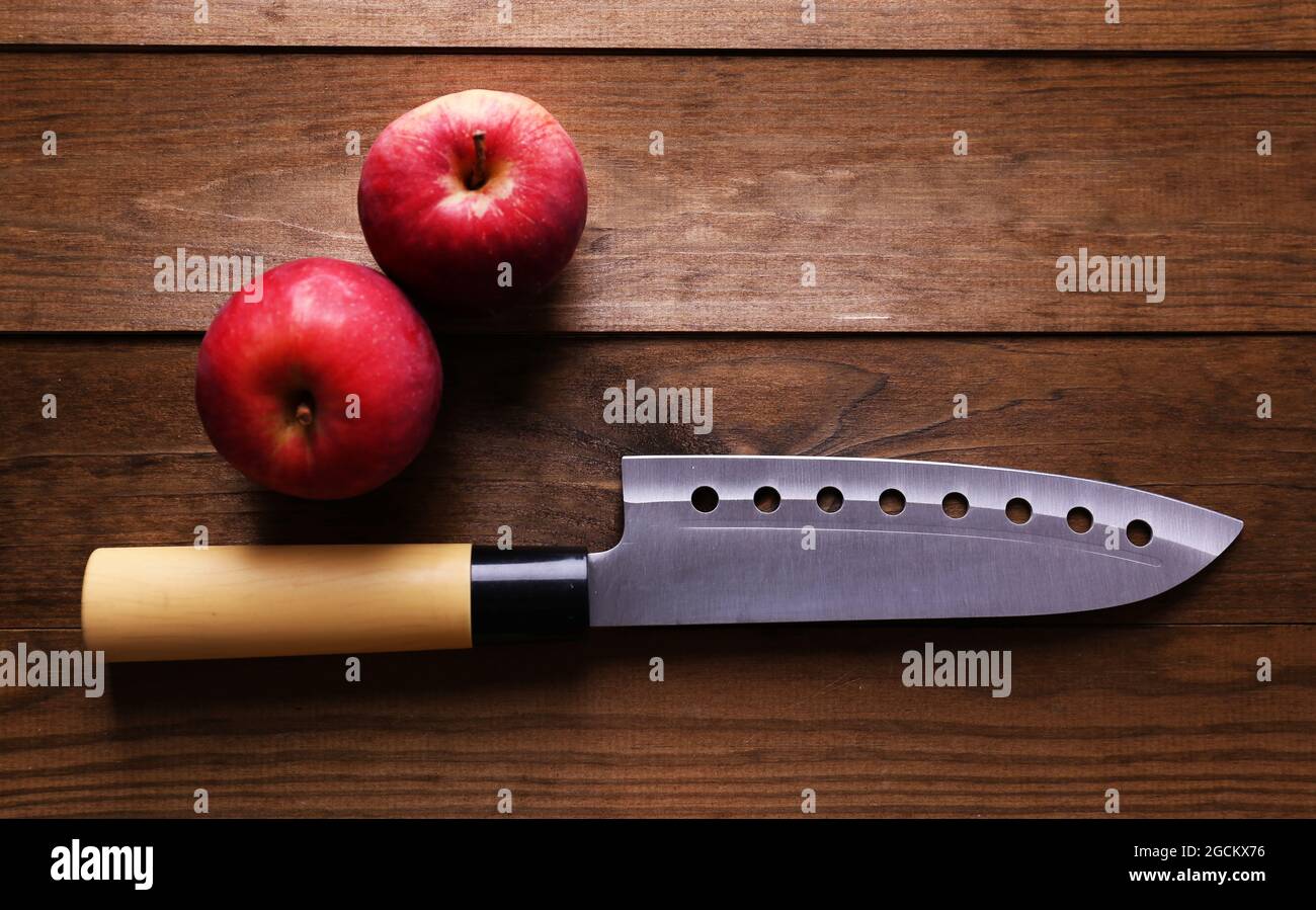 Kitchen knife and apple, on wooden background Stock Photo - Alamy