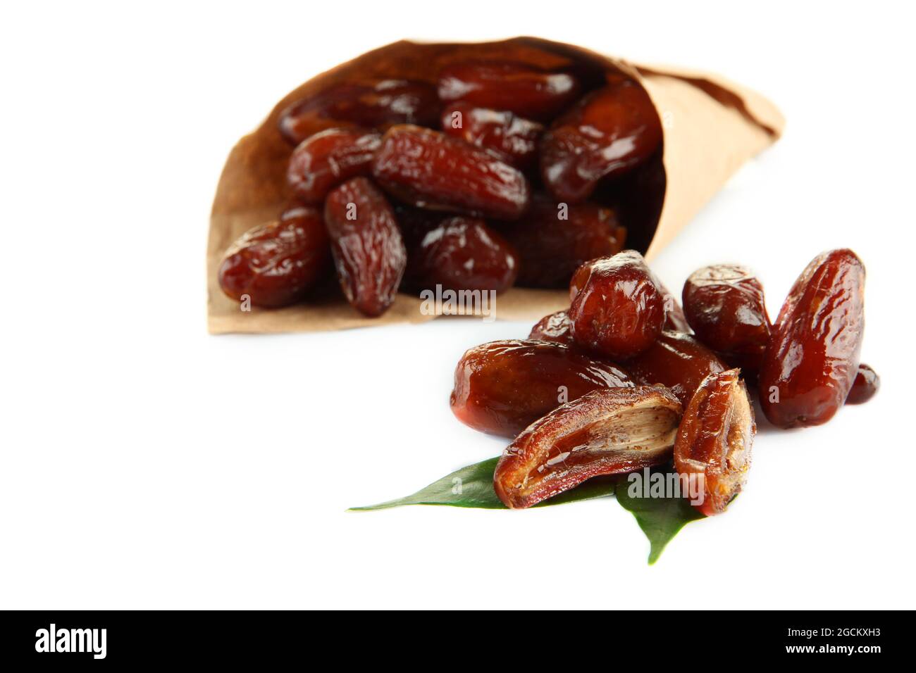 Dried dates in paper cone isolated on white Stock Photo - Alamy