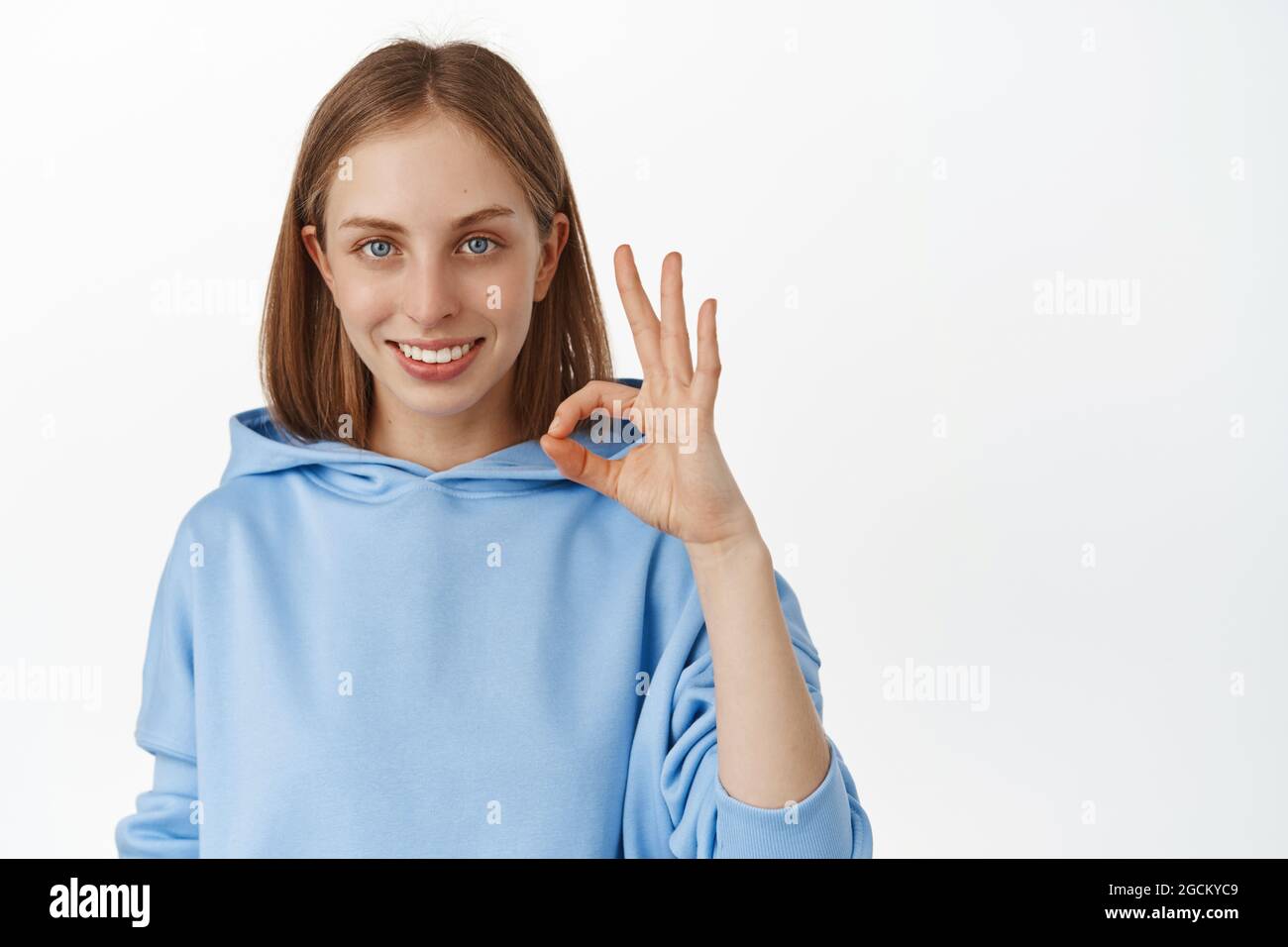 Image of young confident caucasian woman showing ok, okay zero sign and ...