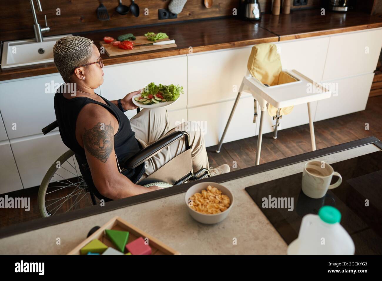 High angle portrait of contemporary tattooed woman with disability in ...