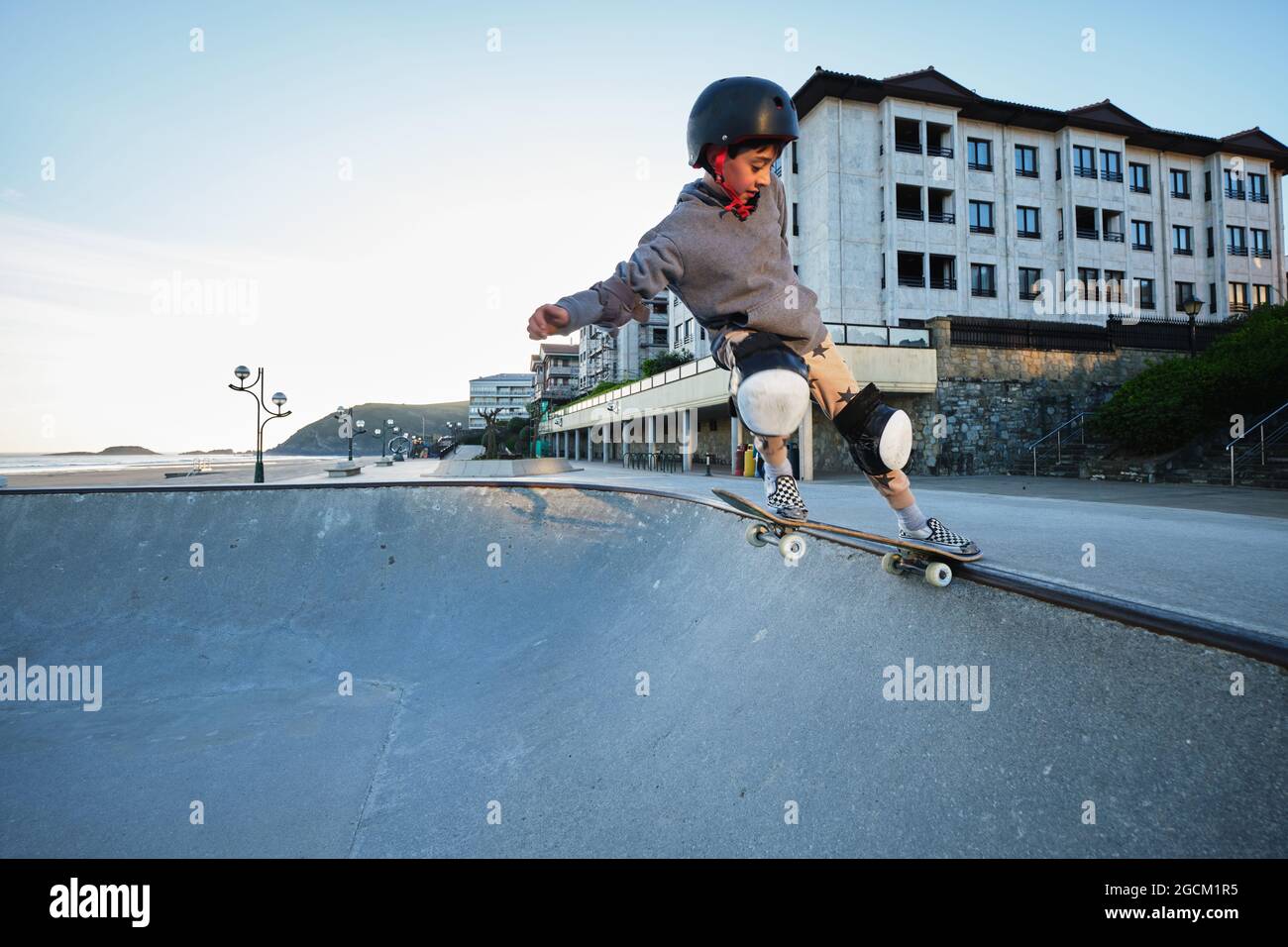 From above of teen boy showing stunt on skateboard while practicing on ...
