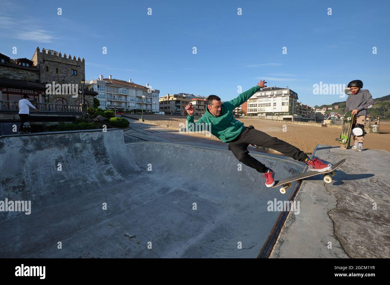 Back view of unrecognizable female walking on sand inside spacious ...