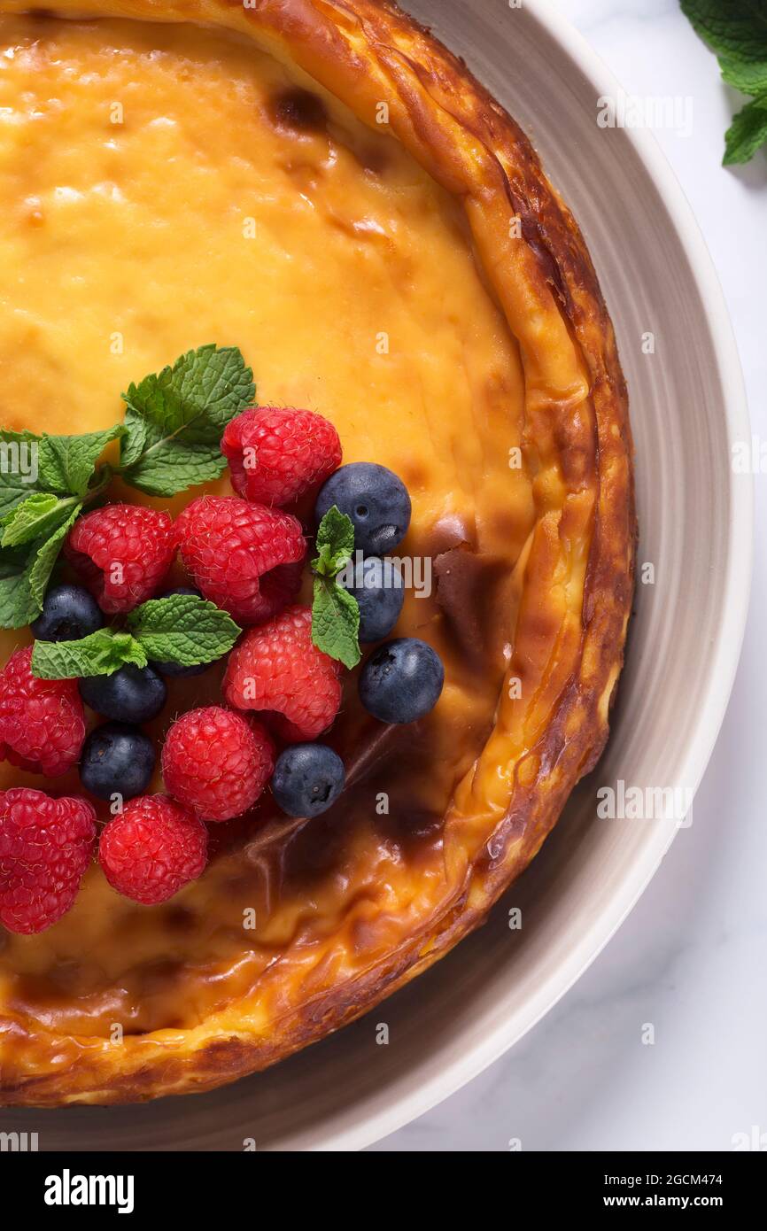 From above crop view of cheesecake decorated with raspberries ...