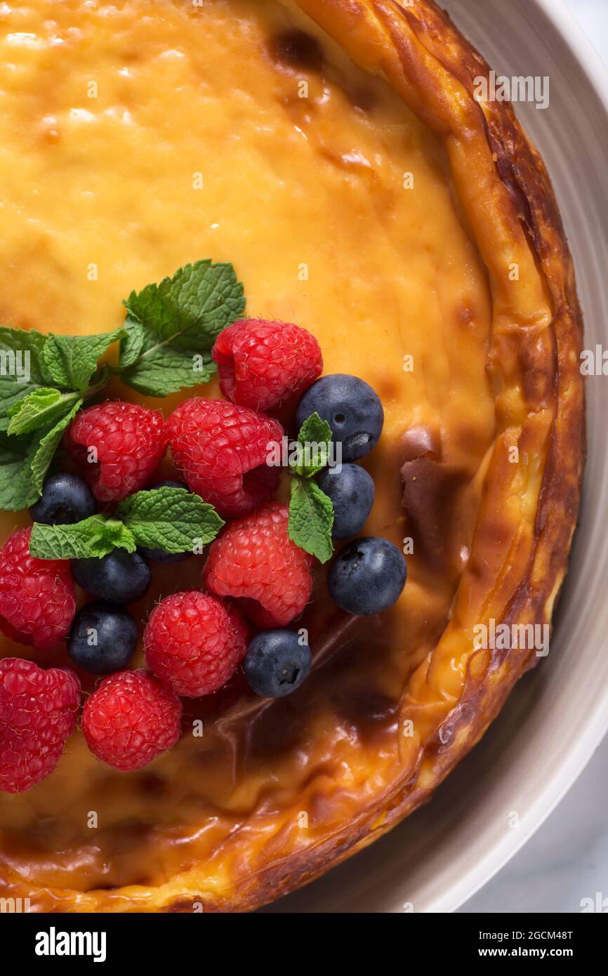 From above crop view of cheesecake decorated with raspberries ...
