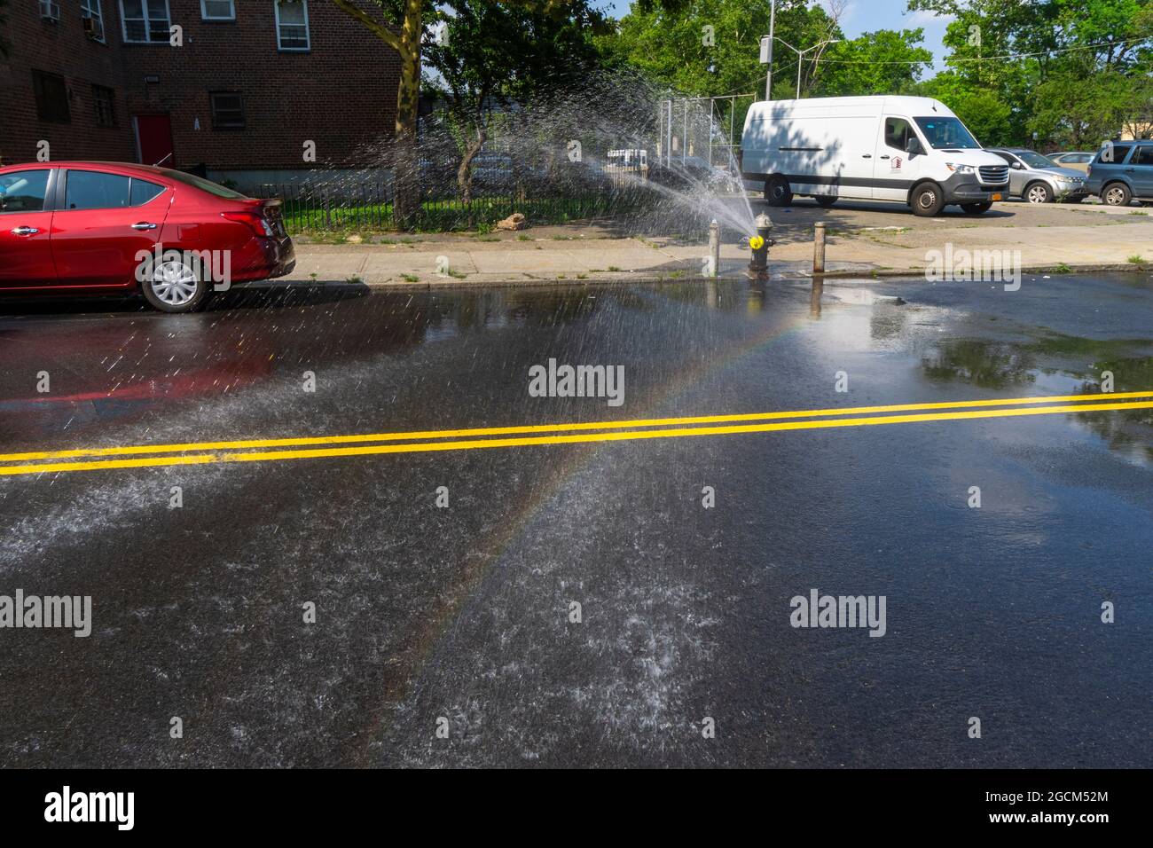 Splashing water from the Fire hydrant makes rainbow on the Street in ...