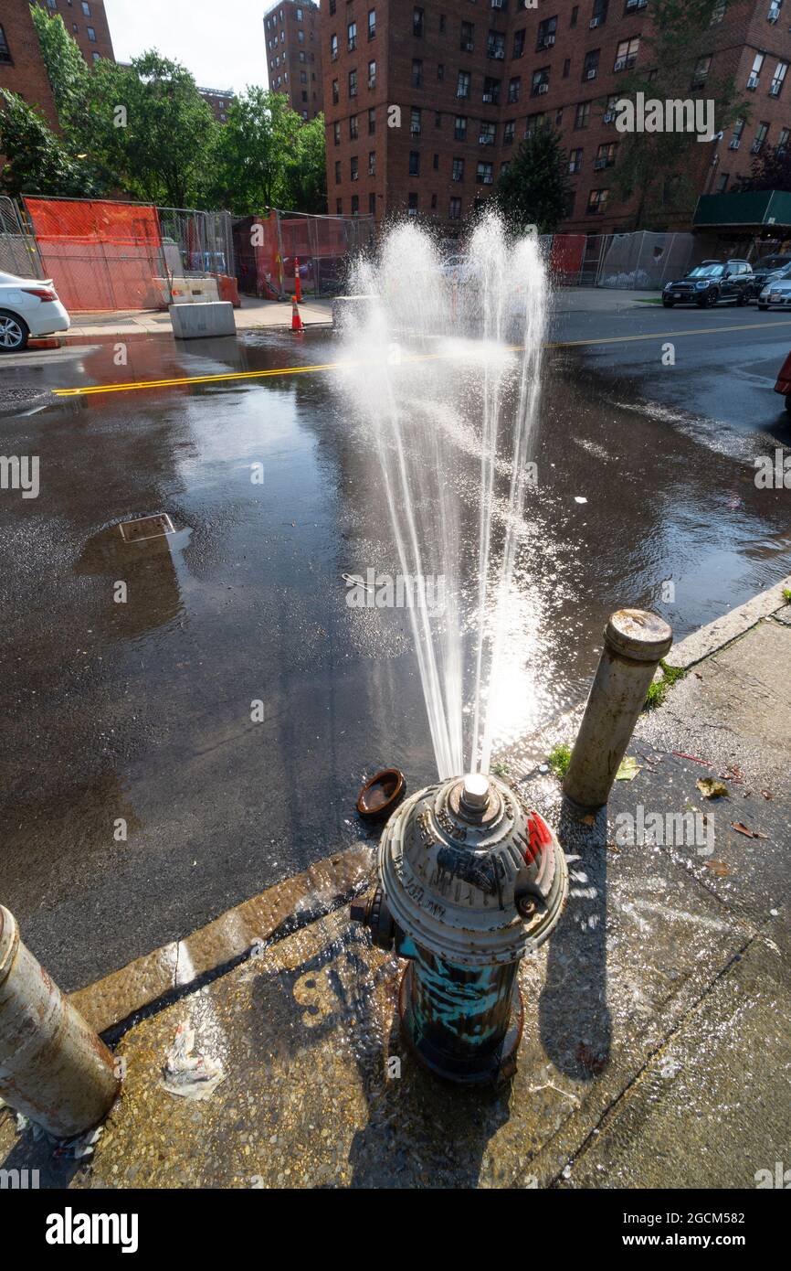 Splashing water from the Fire hydrant makes rainbow on the Street in ...