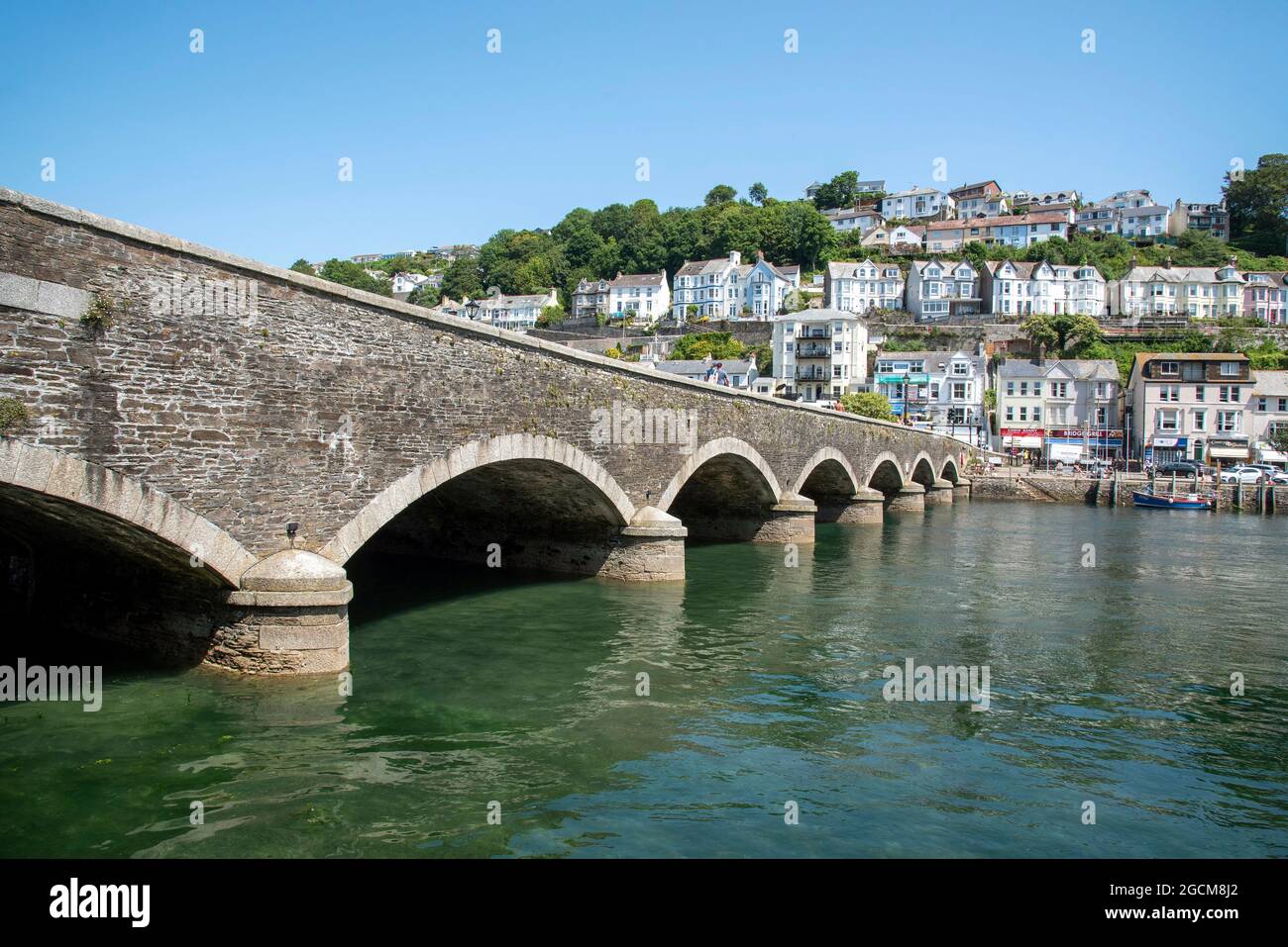Looe, Cornwall, England, UK. 2021. Stone road bridge crossing the tidal ...