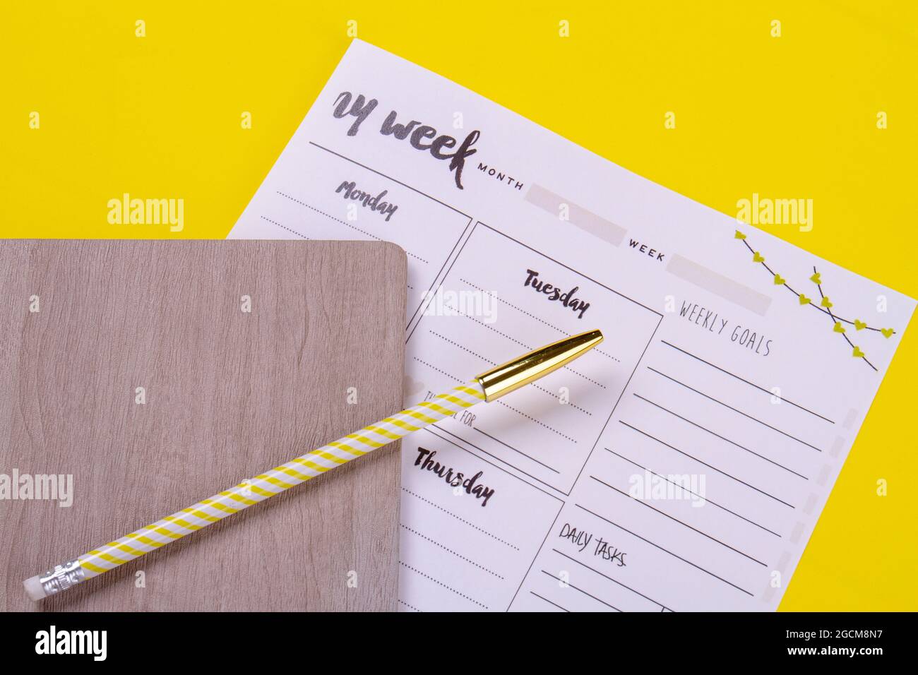 Day planning paper with book and pencil Stock Photo - Alamy