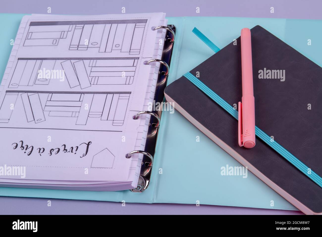 Open blue folder with copybook and pen Stock Photo - Alamy