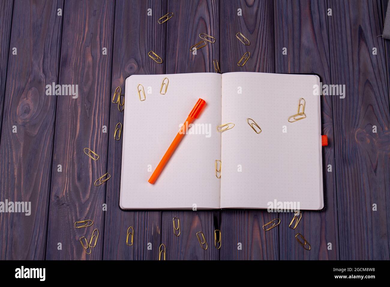 Open book with pen and paper clips Stock Photo - Alamy