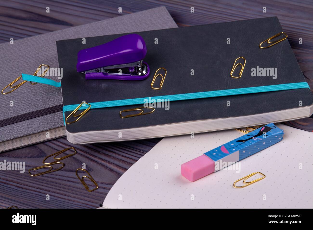 Close-up books with stapler and eraser with paper clips Stock Photo - Alamy