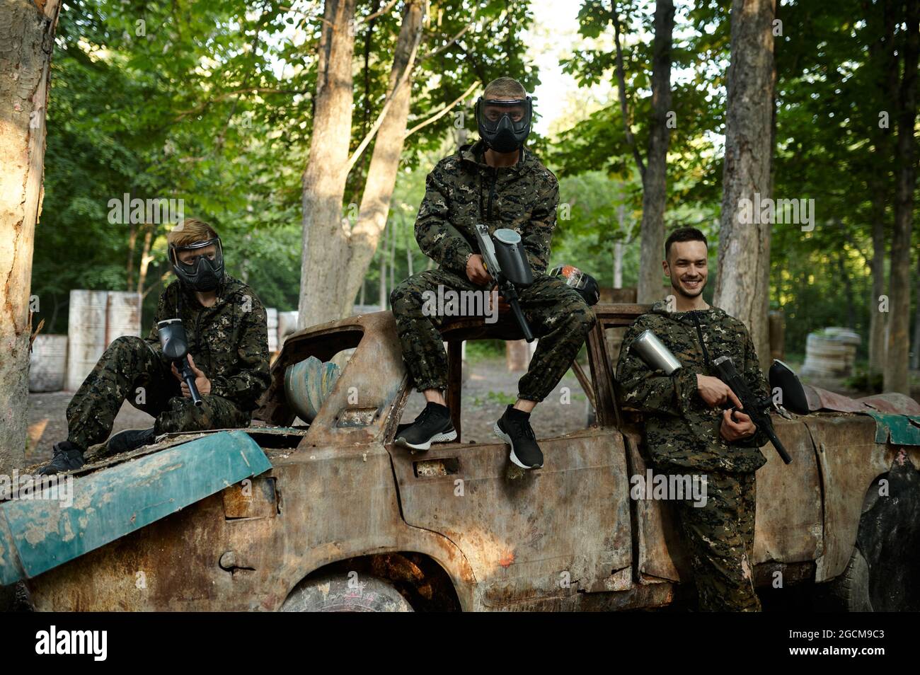 Paintball team, friends poses on playground Stock Photo - Alamy