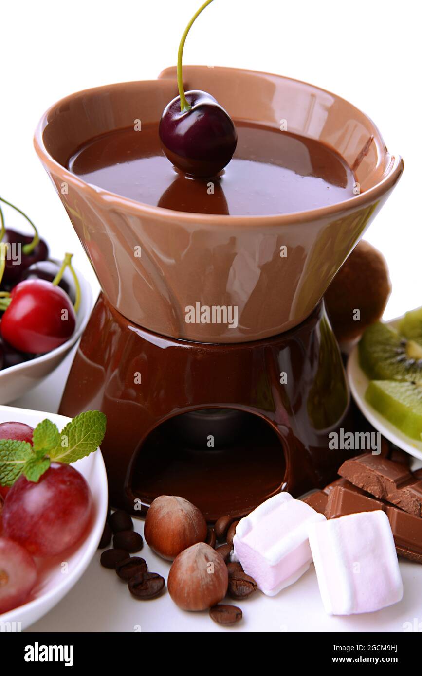Chocolate fondue with sliced fruits, isolated on white Stock Photo - Alamy