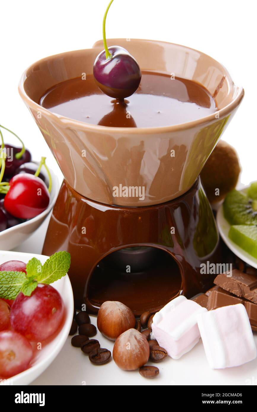 Chocolate fondue with sliced fruits, isolated on white Stock Photo - Alamy