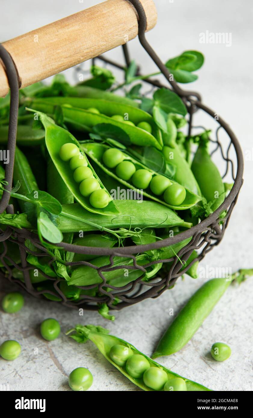 Fresh green peas pods and green peas with sprouts on concrete ...