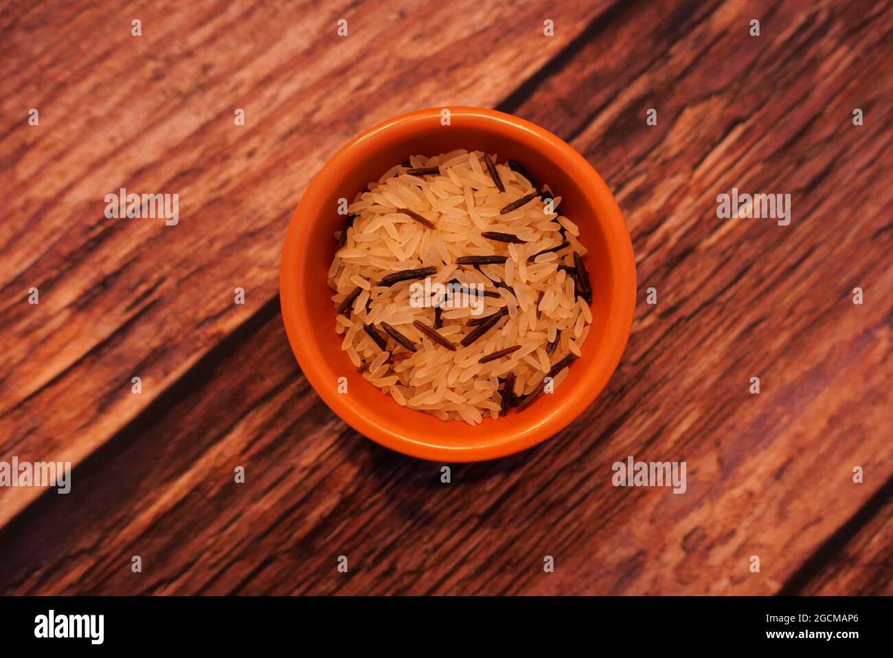 Small terracotta pot of wild rice on dark wooden background Stock Photo ...