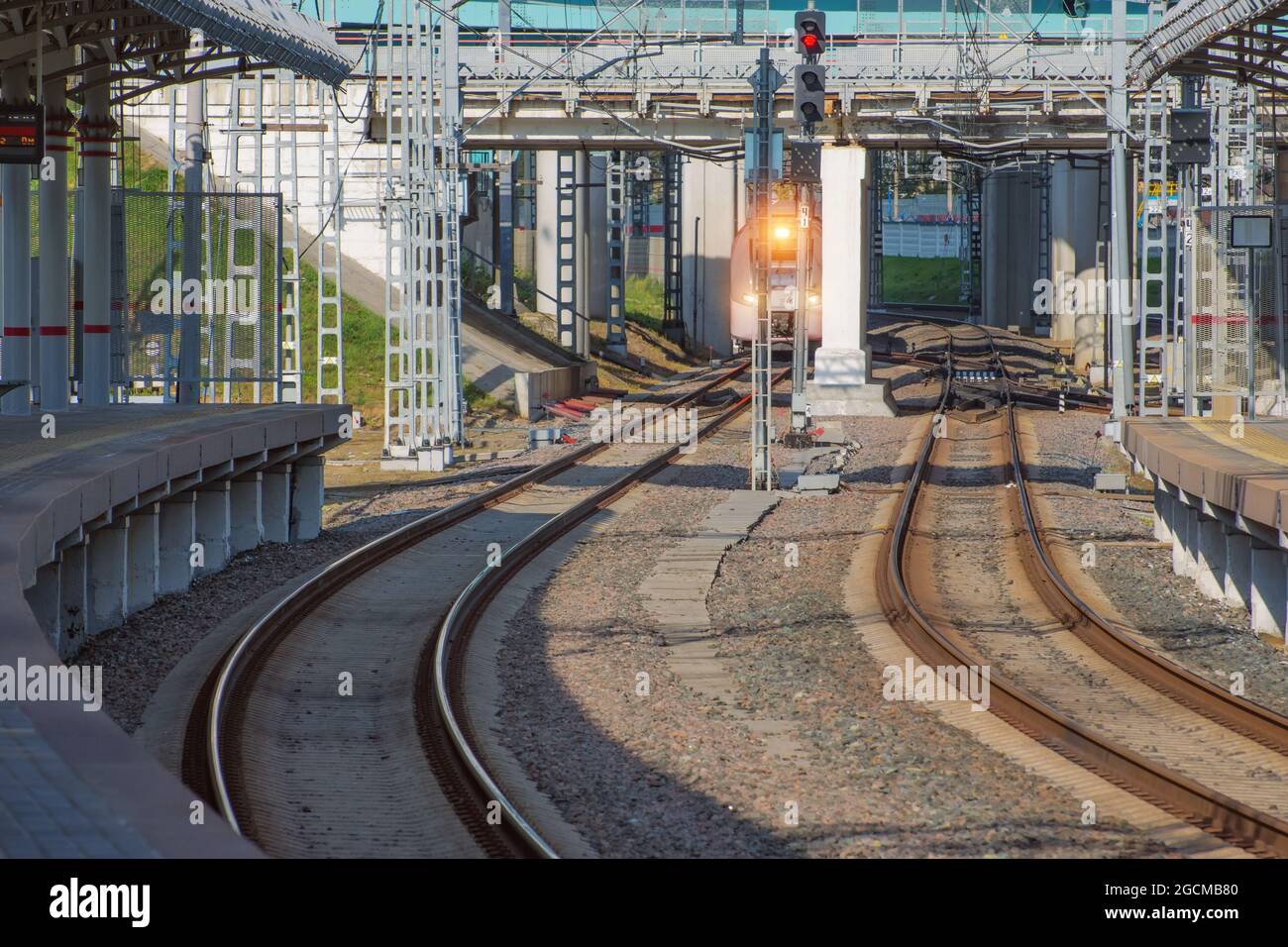 Passenger empty platform without people at the turn of the railway and ...