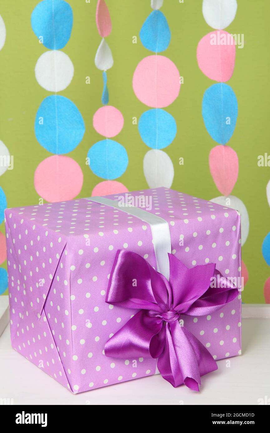 Beautiful present on table on bright background Stock Photo - Alamy
