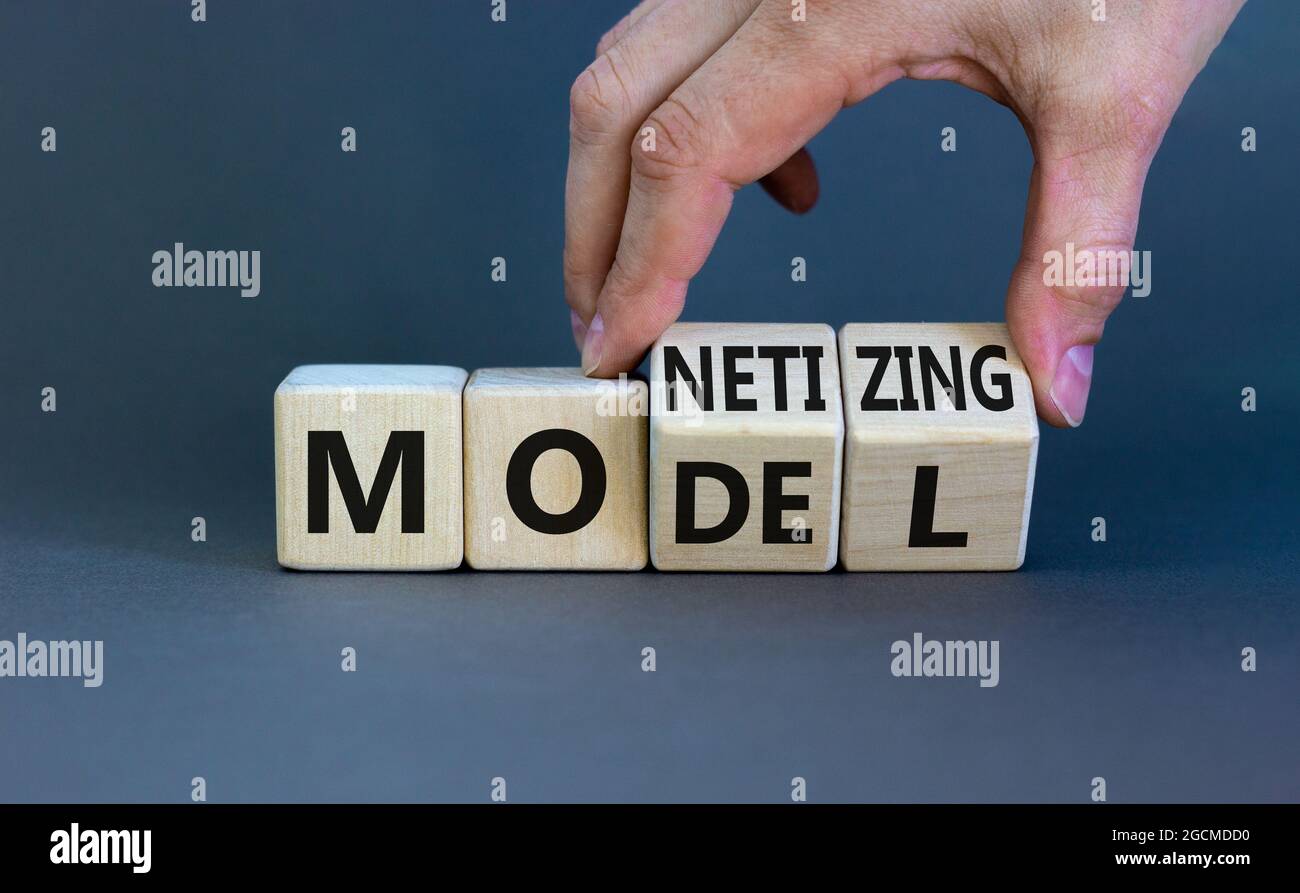 Monetizing model symbol. Businessman turns wooden cubes and changes the ...