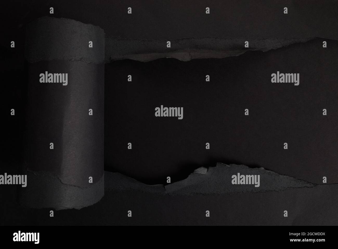 Torn black paper on black background. Top view Stock Photo - Alamy