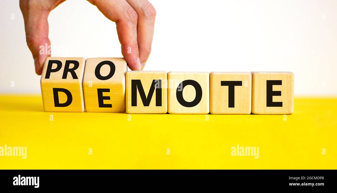 Promote or demote symbol. Businessman turns cubes and changes the word ...
