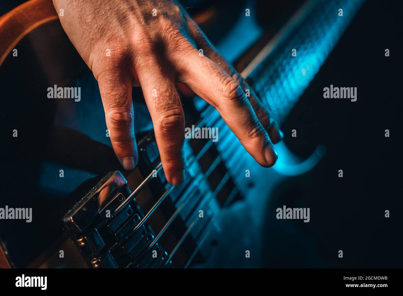 Closeup of male fingers playing 5 stringed electric bass guitar Stock ...