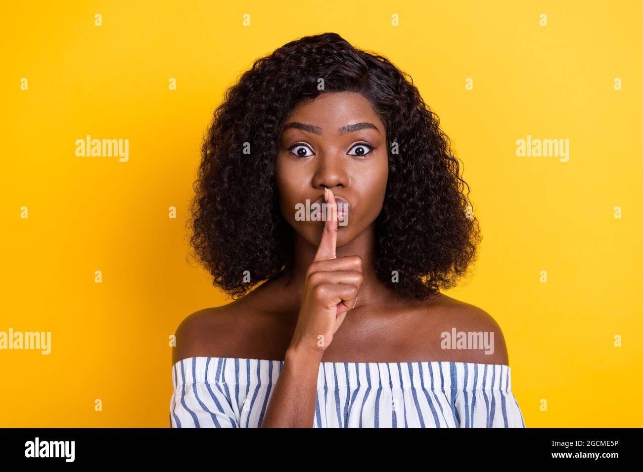 Close-up portrait of attractive mysterious brunette girl showing shh ...