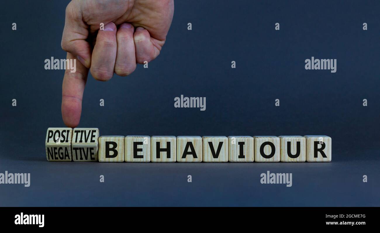 Positive or negative behaviour symbol. Businessman turns cubes, changes ...
