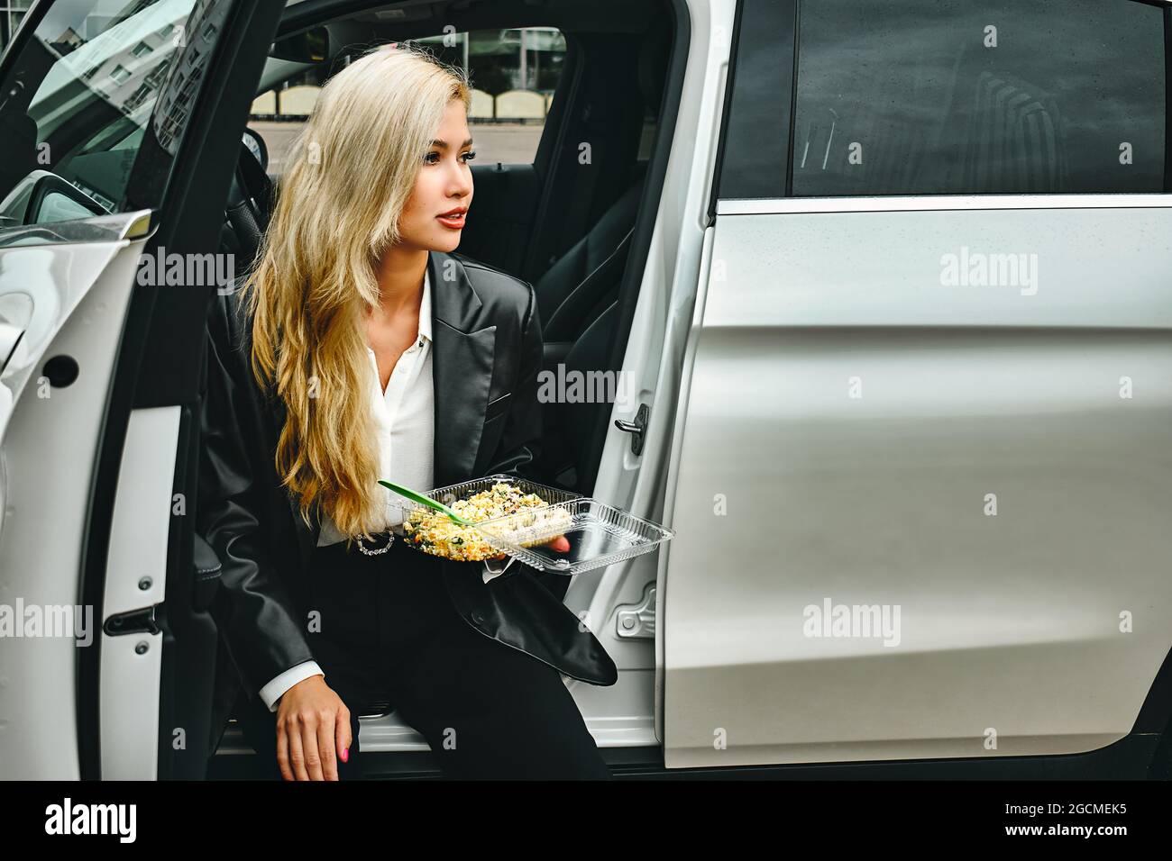 business lunch in the car. girl eating fast food on the road Stock ...