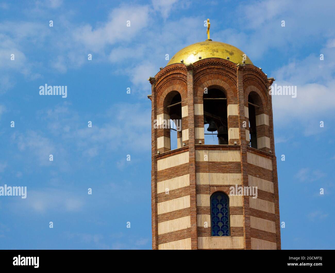 Religion symbol. Beautiful church tower with cross, toller and red tile ...