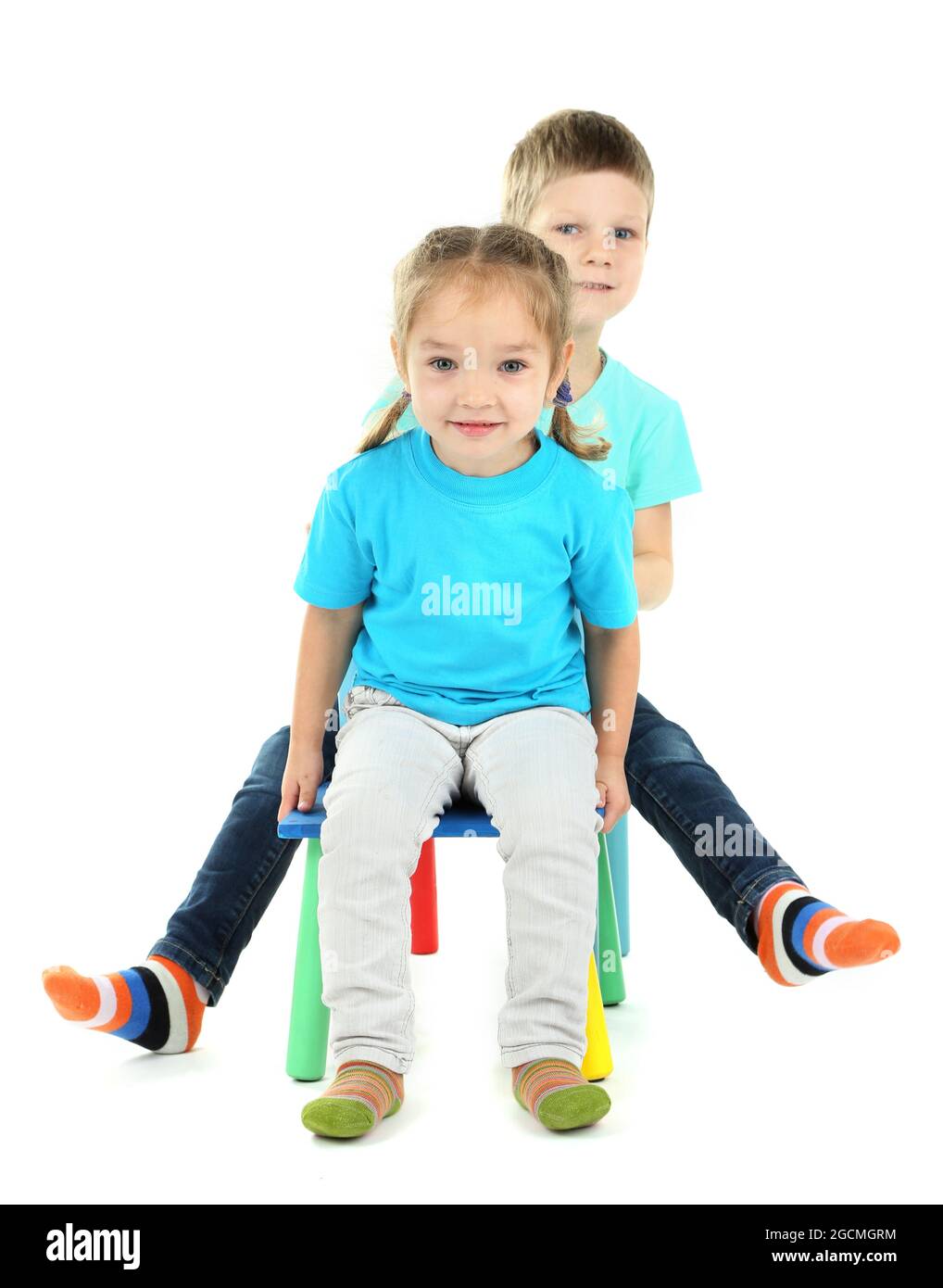 Little children playing on chairs isolated on white Stock Photo - Alamy