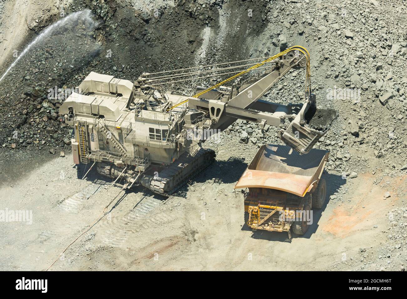 Electric rope shovel loading a dump truck at a copper mine in Chile ...