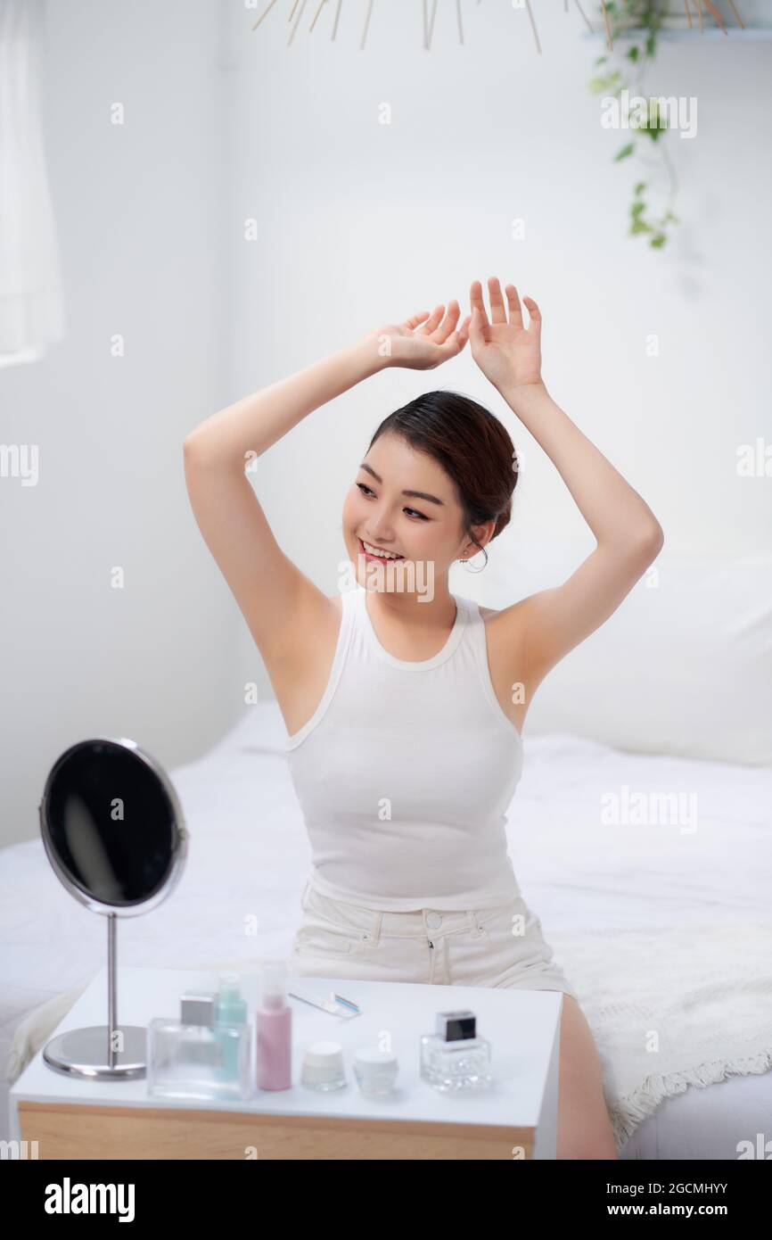Slim young woman shows tender smooth armpit skin in bedroom Stock Photo ...
