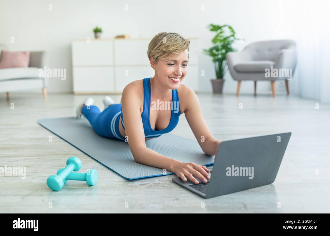 Woman lying on blue mat hi-res stock photography and images - Alamy