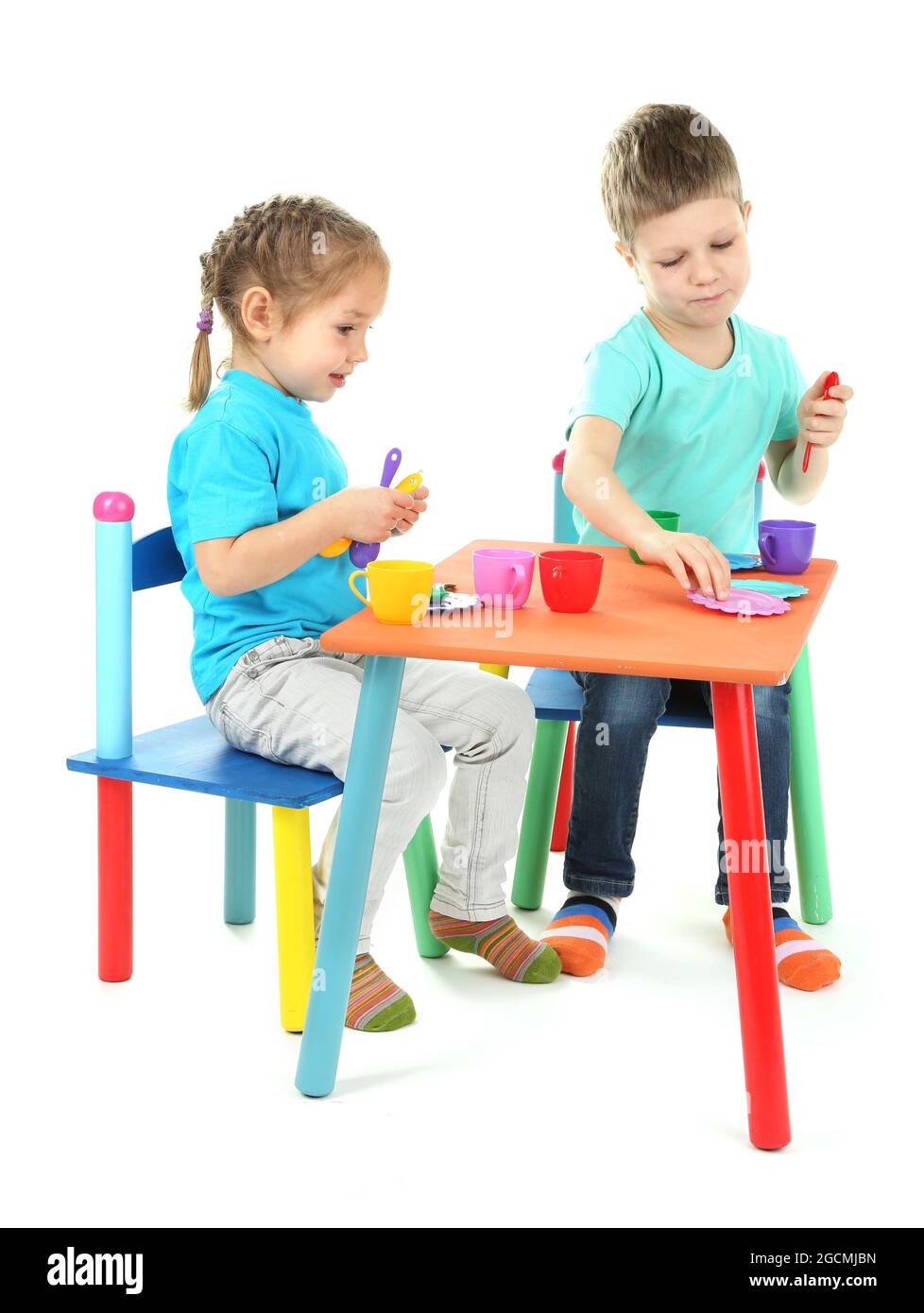Little children playing with colorful tableware isolated on white Stock ...