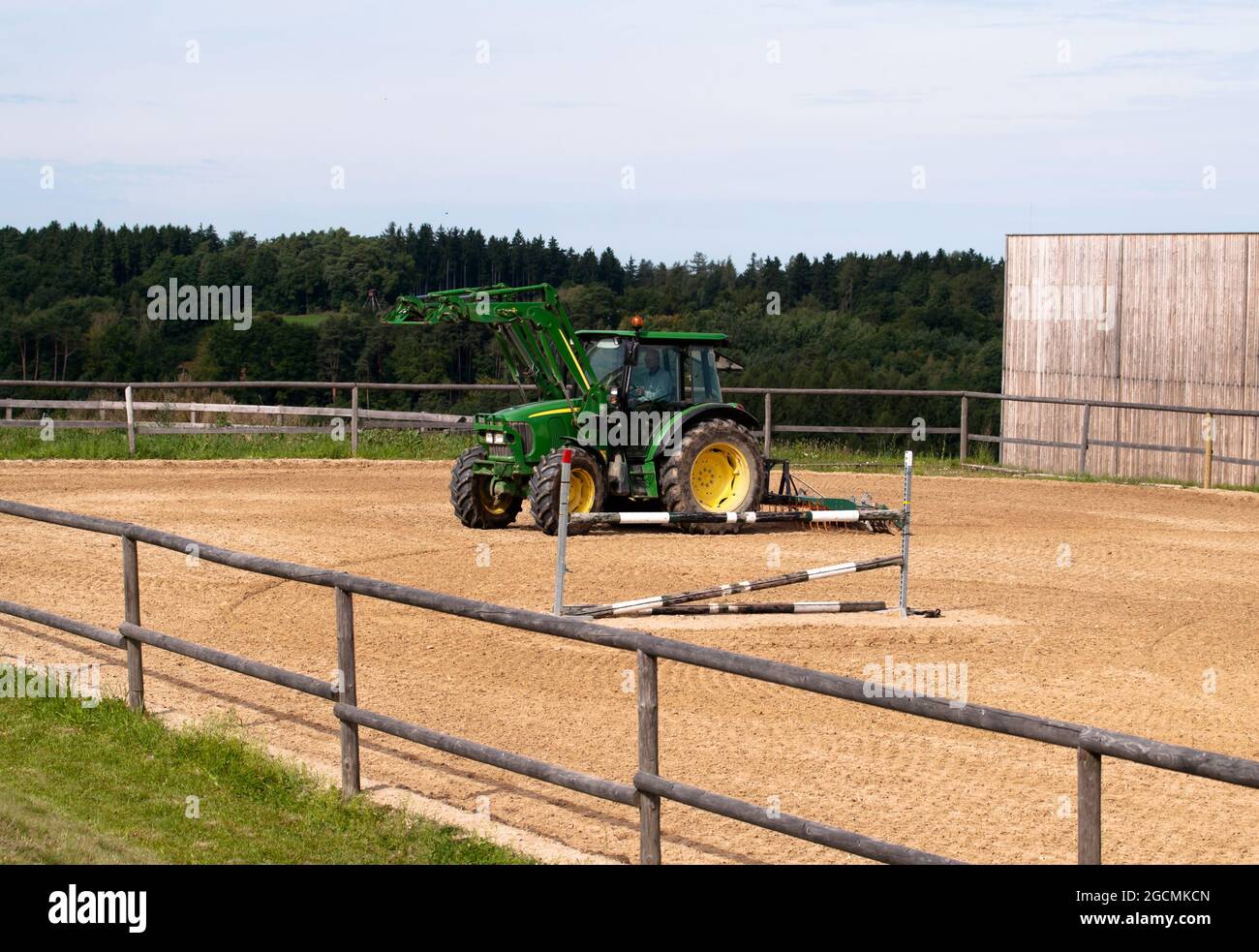 Tractor preparing arena for equine competition Stock Photo - Alamy