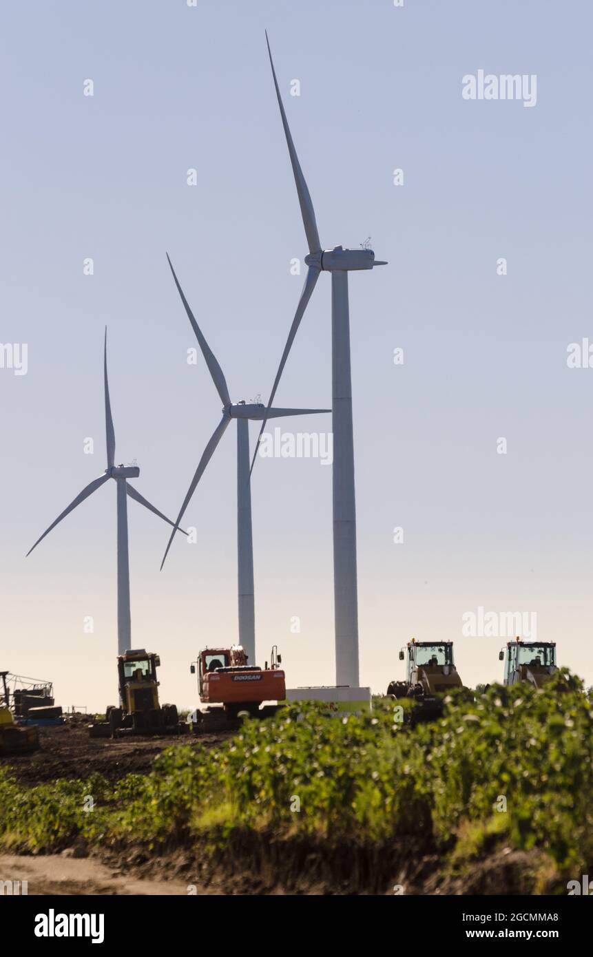 Set of three wind turbines and other heavy machinery used for the ...
