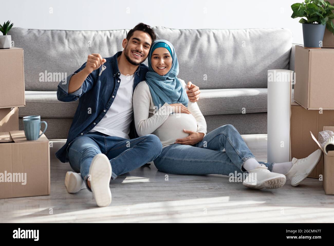Loving expecting family showing key from new apartment Stock Photo - Alamy